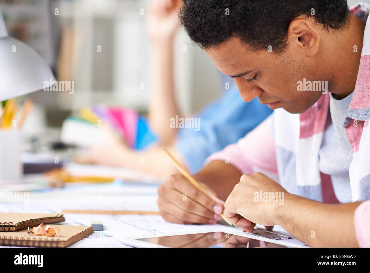 Young engineer making sketch of construction Stock Photo - Alamy