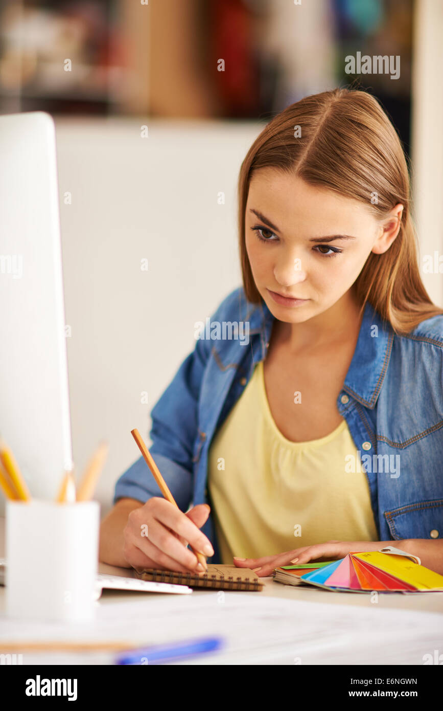 Portrait of pretty designer making sketch in notepad Stock Photo - Alamy