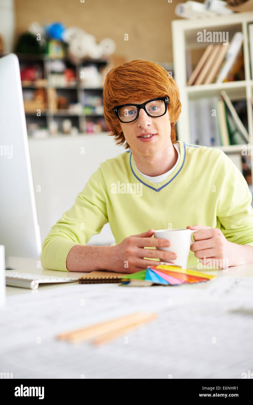 Happy businessman looking at camera while having tea at work Stock ...