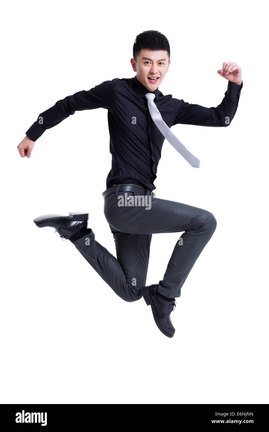 Cheerful young man jumping Stock Photo - Alamy