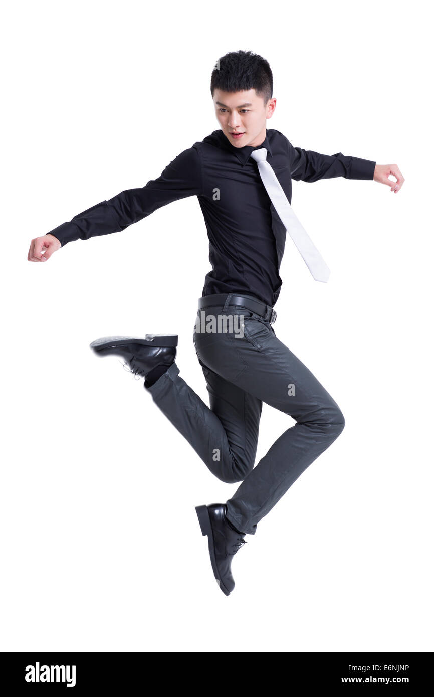 Cheerful young man jumping Stock Photo - Alamy