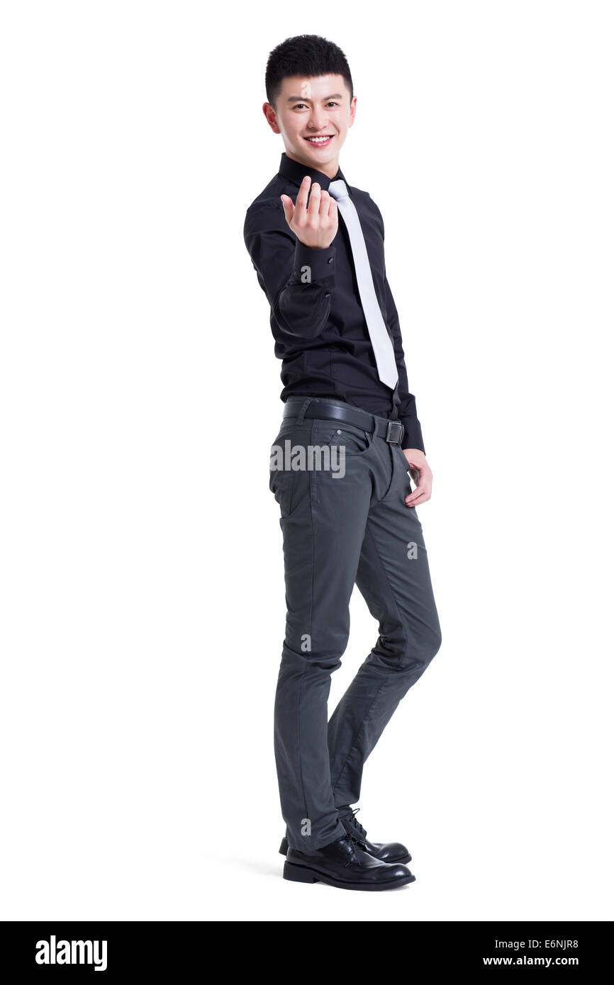 Happy young man beckoning with hand Stock Photo - Alamy