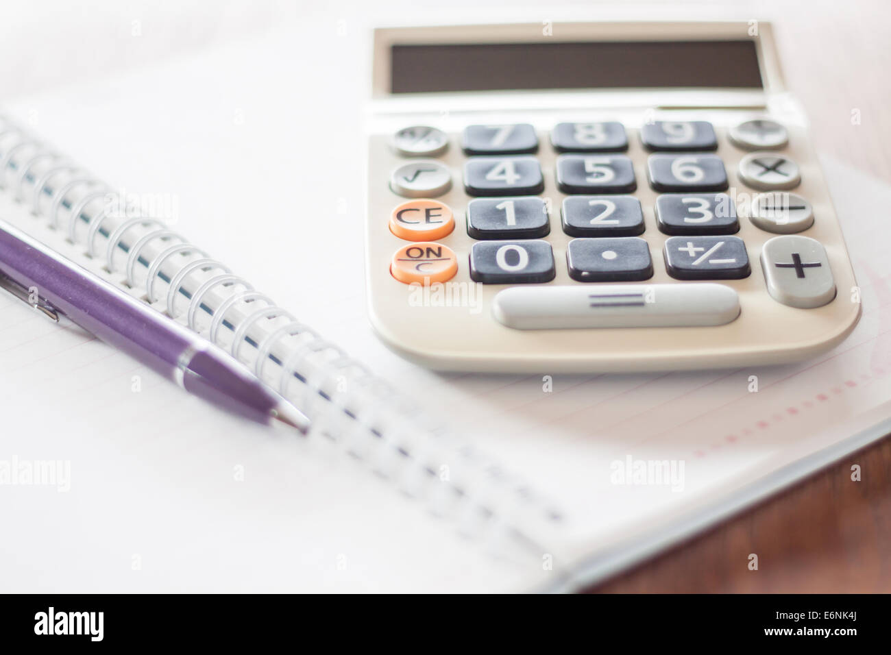Calculator and pen on notebook, stock photo Stock Photo - Alamy