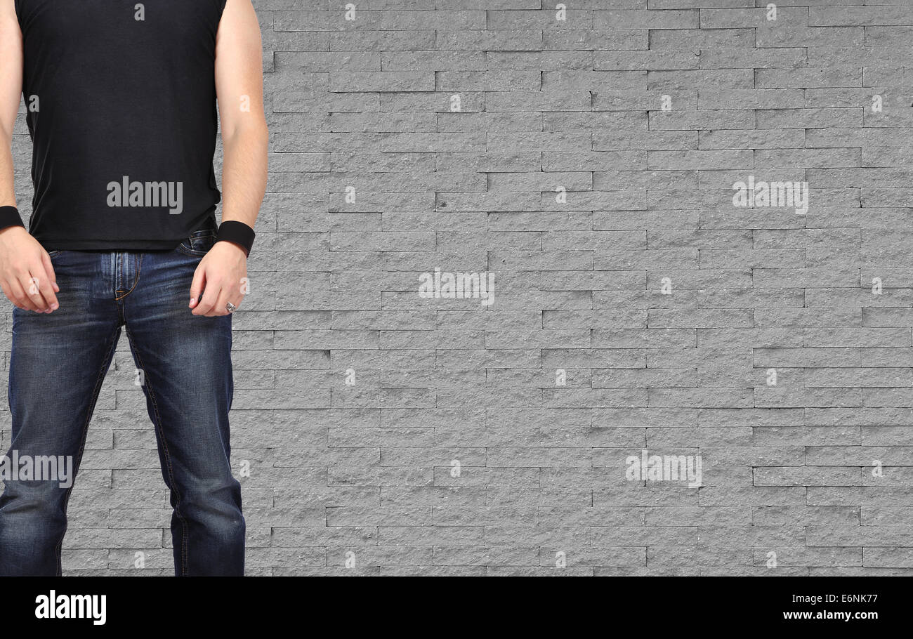 rock men standing on brick wall backgraund Stock Photo - Alamy