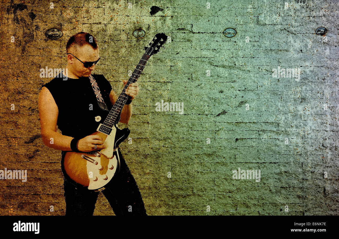 rock musician is playing electrical guitar Stock Photo - Alamy