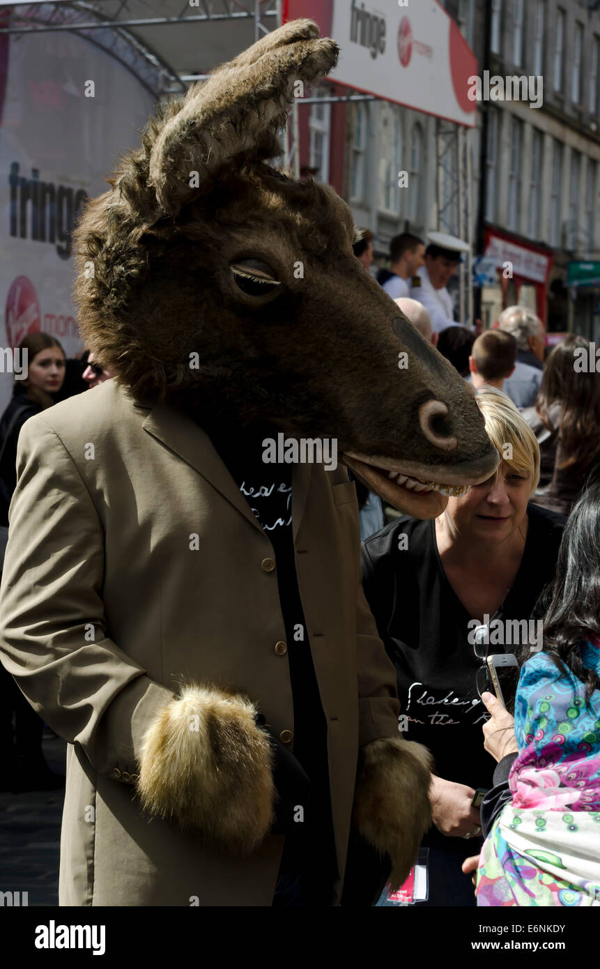 Man wearing a donkey's head (Bottom) promoting a play at the annual ...