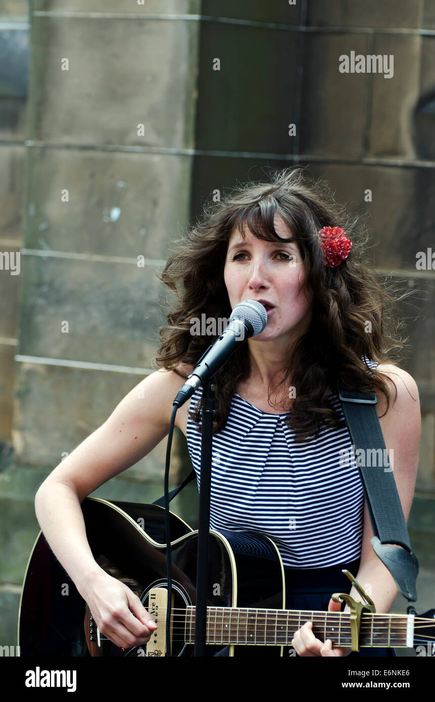 Busker girl playing guitar hi-res stock photography and images - Alamy