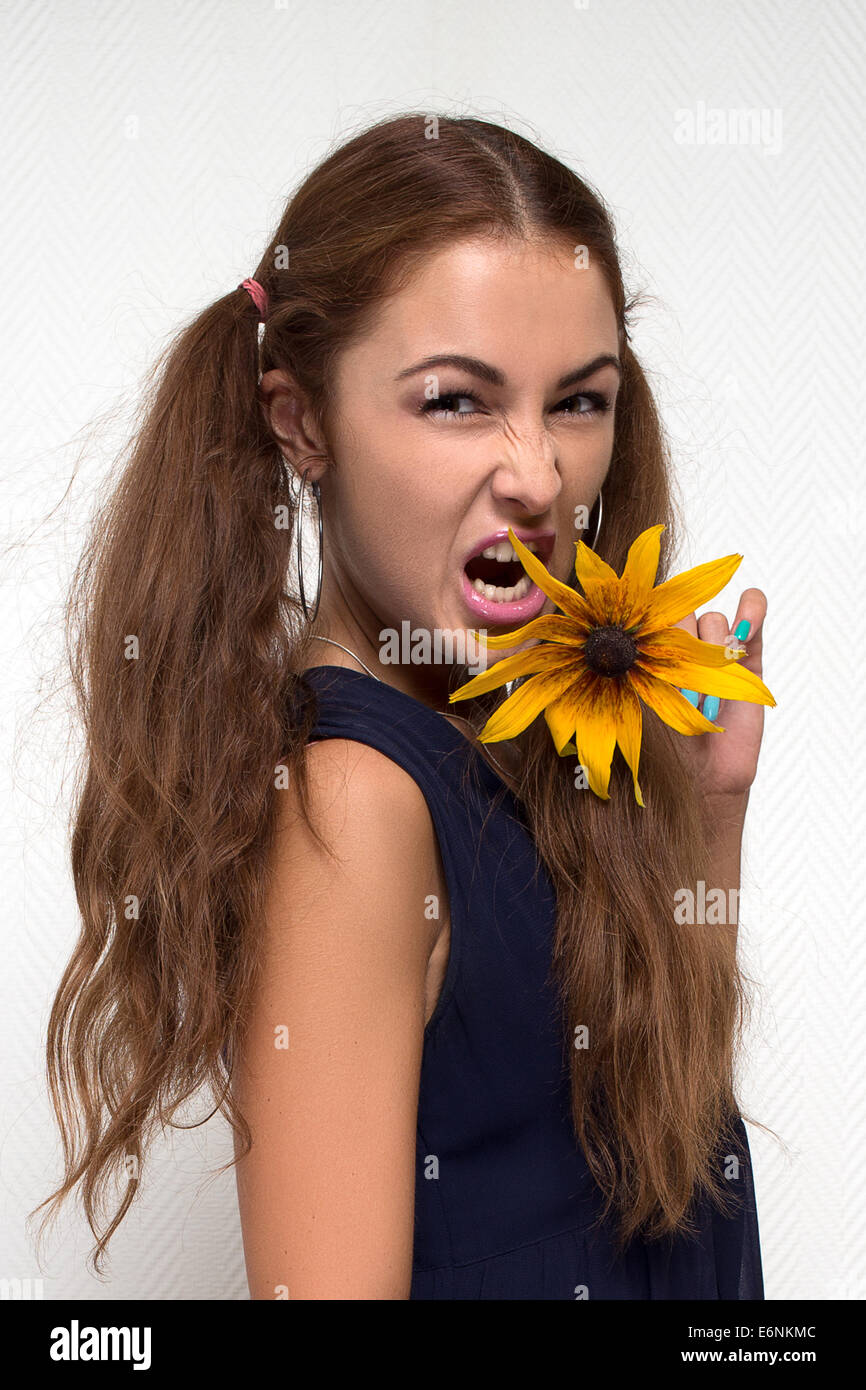 fun emotional woman screaming with yellow flower on white background ...