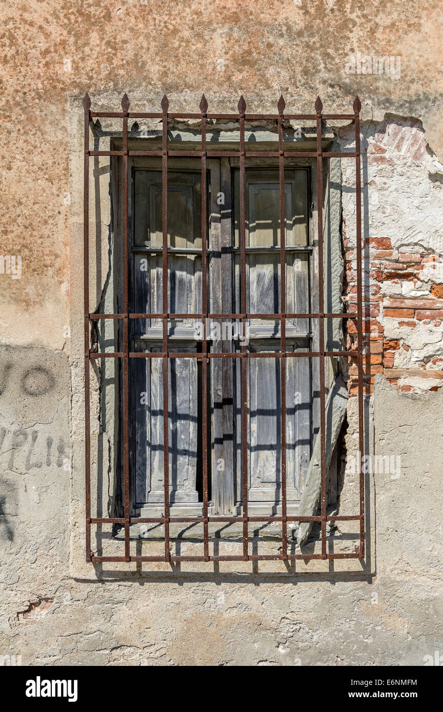 Wooden window shutters protected by metal security bars Stock Photo - Alamy