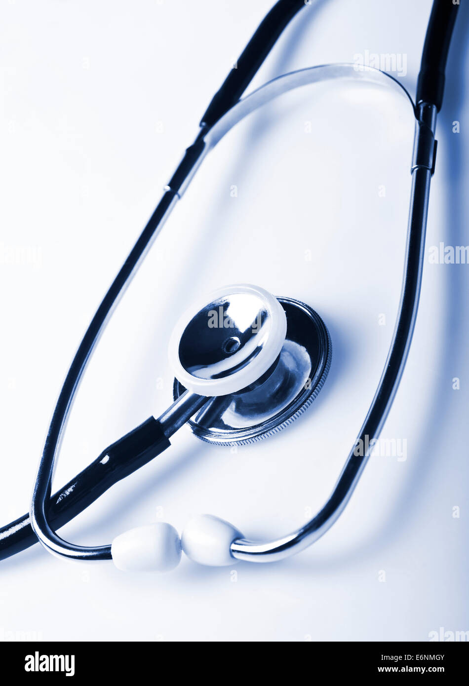 Closeup view of a stethoscope on a white and blue background with deep ...