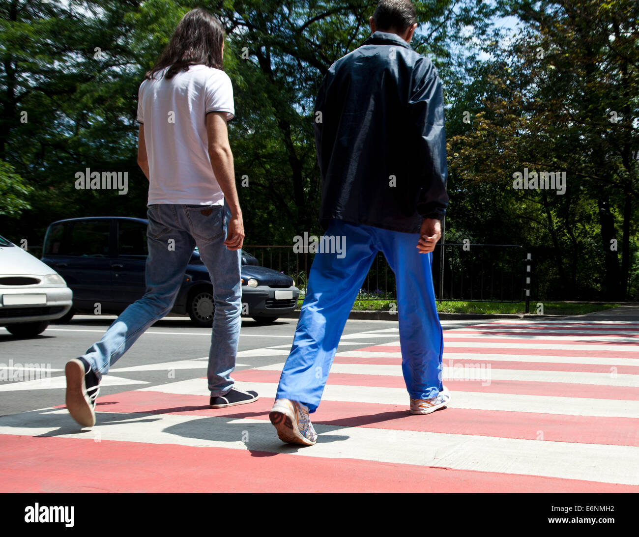 People on pink and white zebra crossing Stock Photo - Alamy