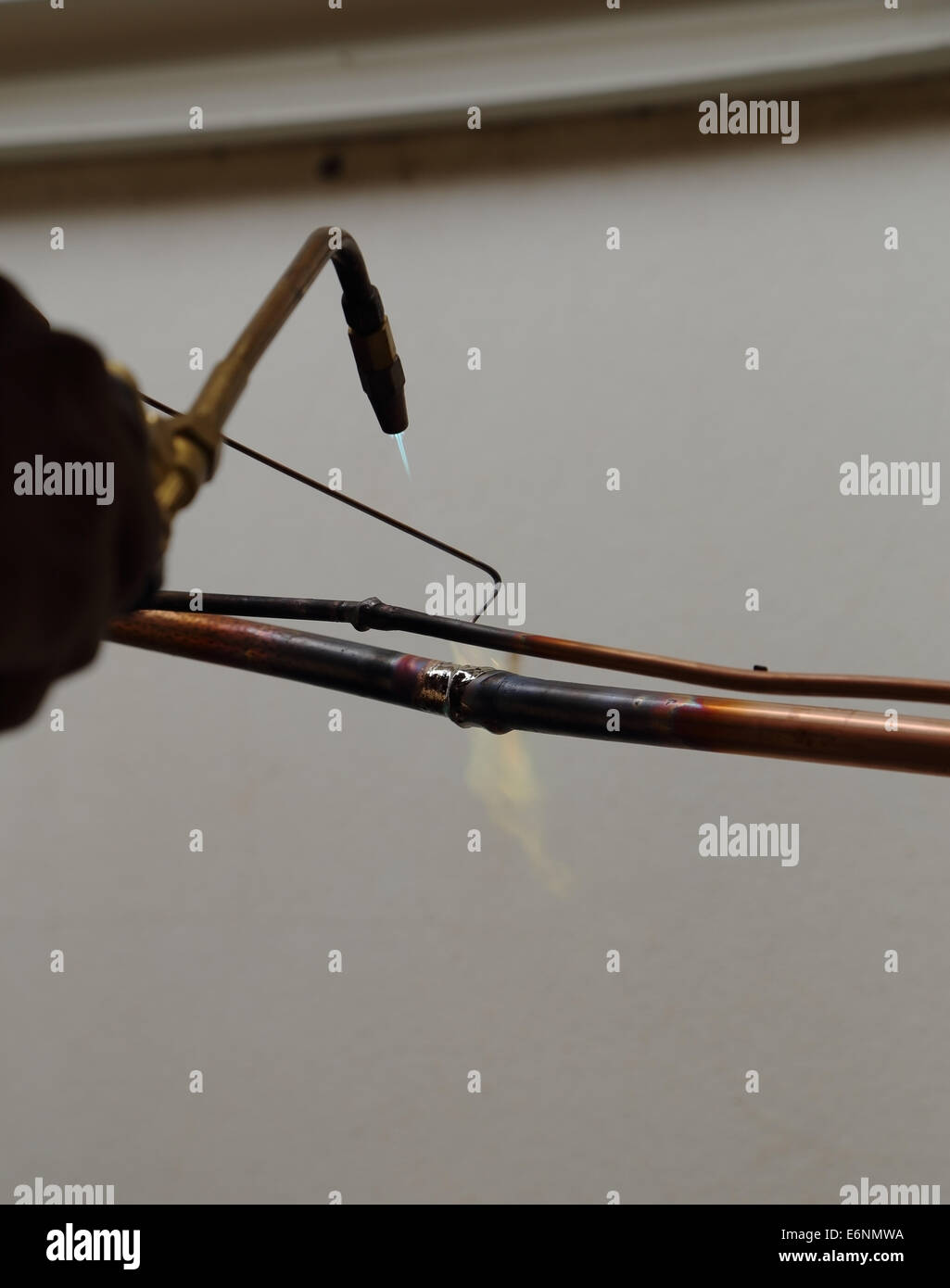 Air conditioner repairman welding copper pipes Stock Photo - Alamy