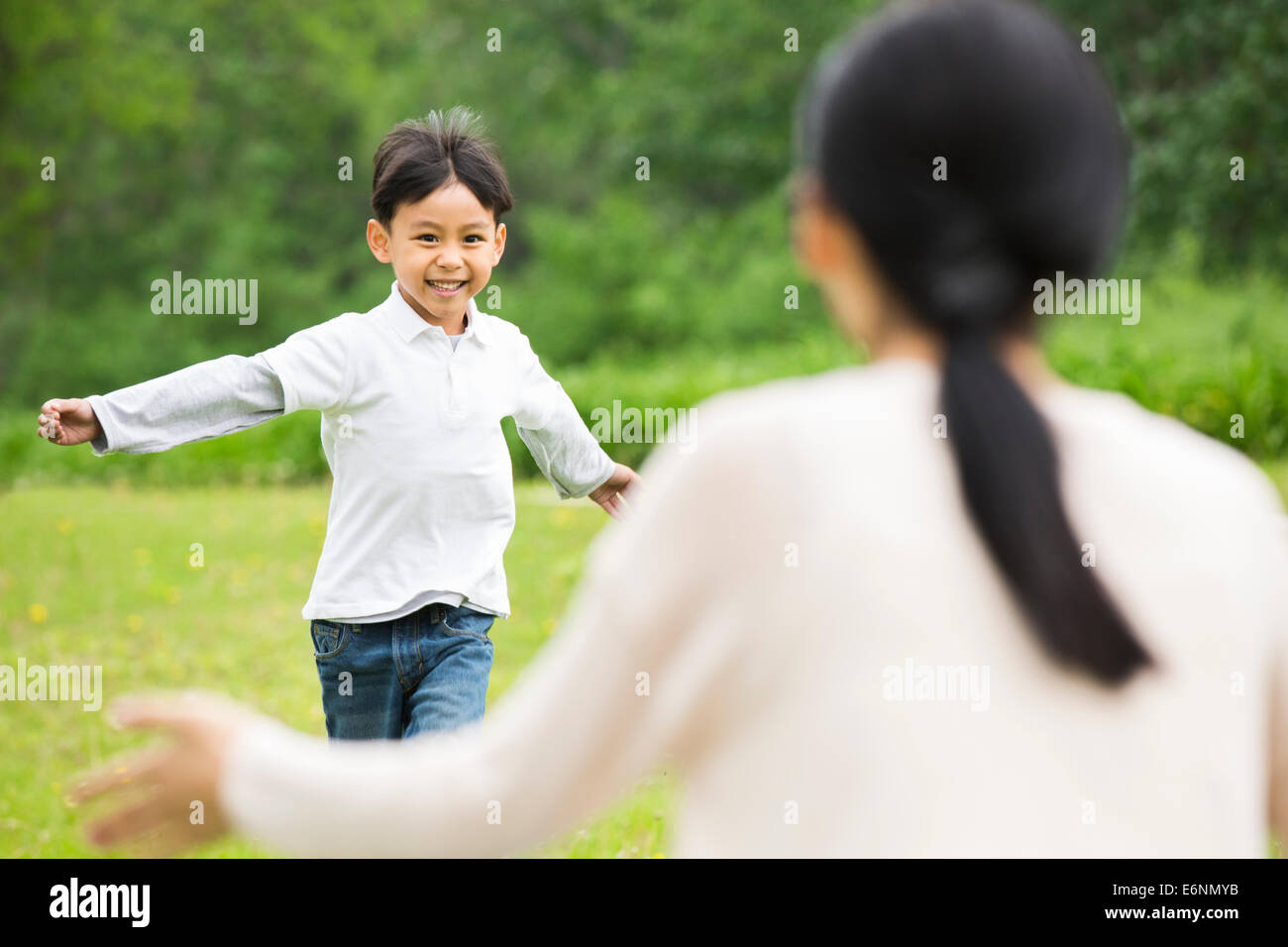 Happy boy running to hug his mother Stock Photo - Alamy