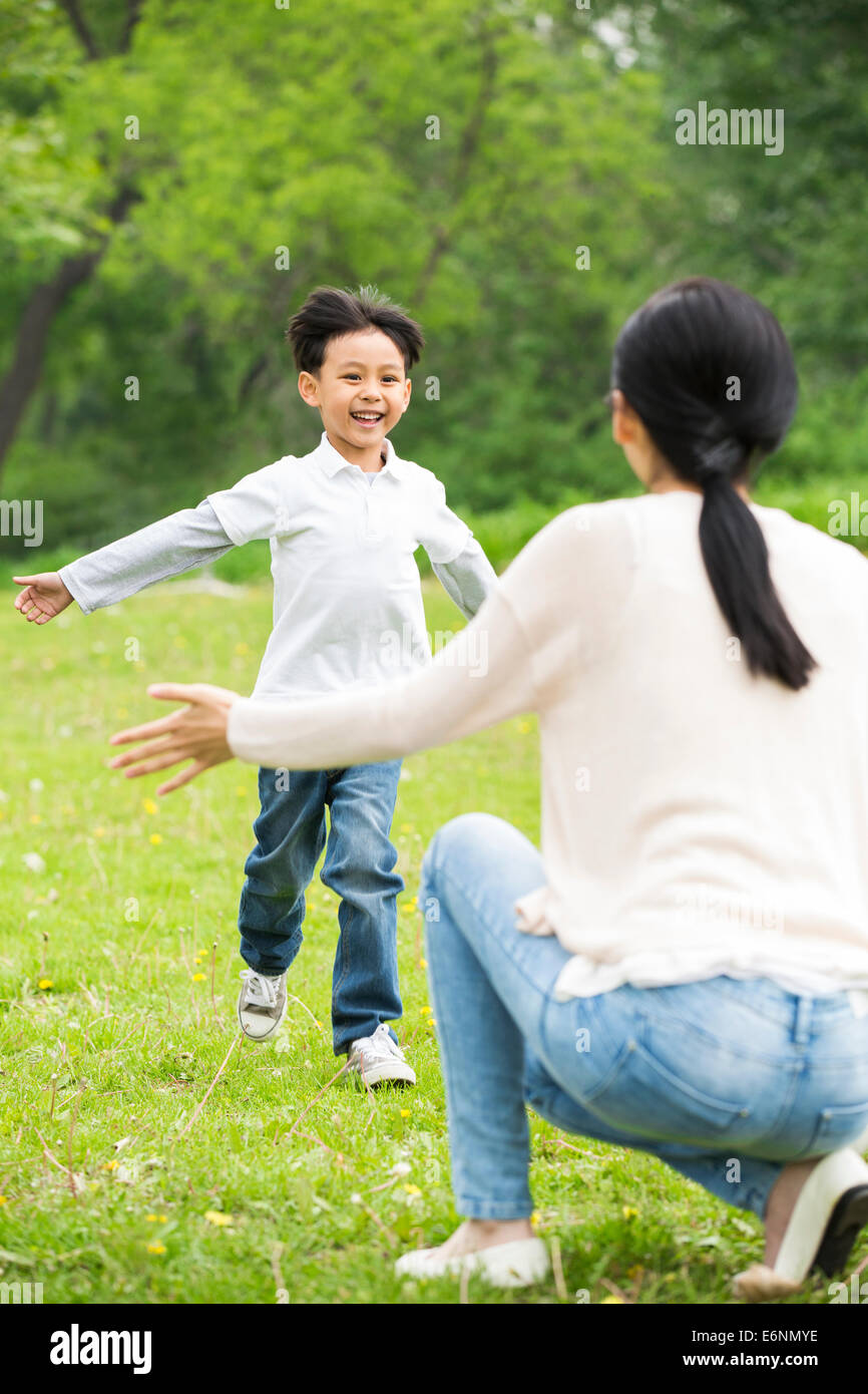 Happy boy running to hug his mother Stock Photo - Alamy