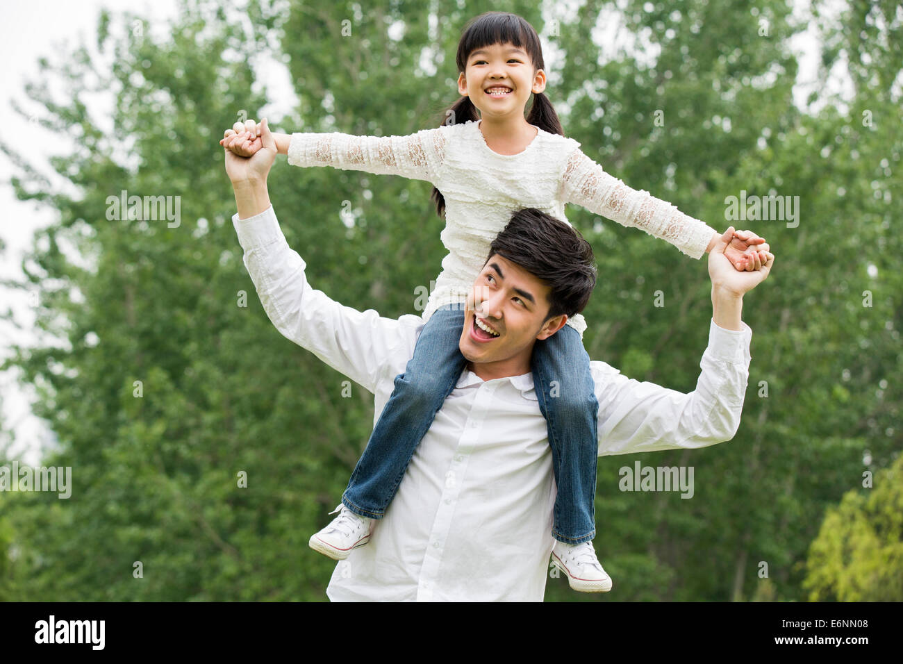Happy father carrying daughter on shoulders Stock Photo - Alamy