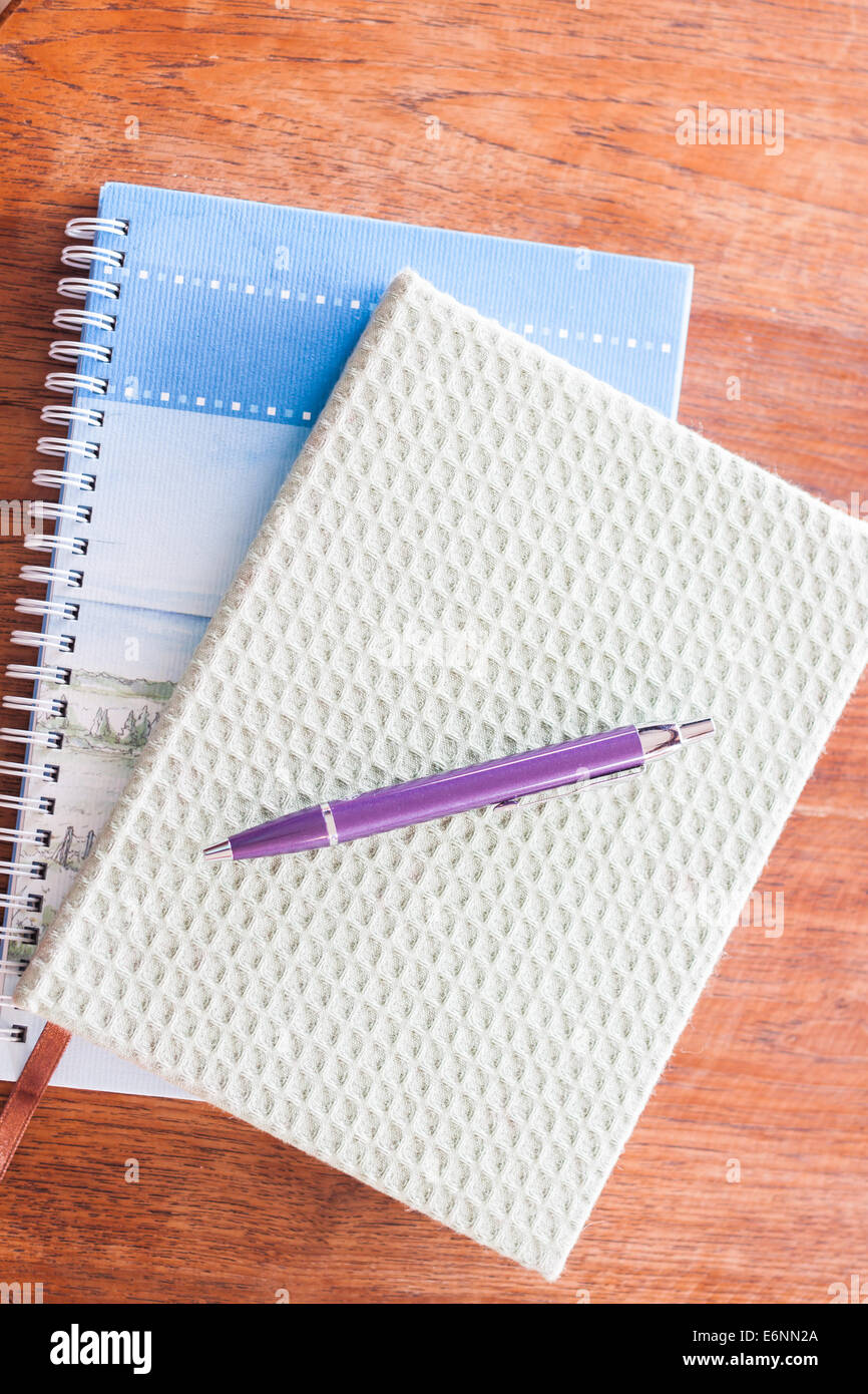 Pen and two of notebooks on wooden table, stock photo Stock Photo - Alamy