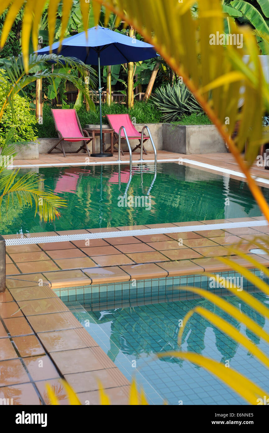 Swimming pool with seats and umbrella at a hotel in Phnom Penh ...