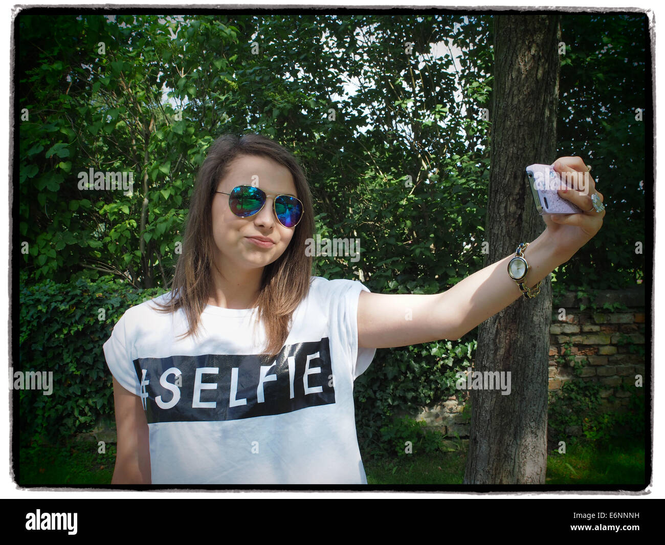 A young woman from Poland wears a t-shirt on which the word Selfie is ...