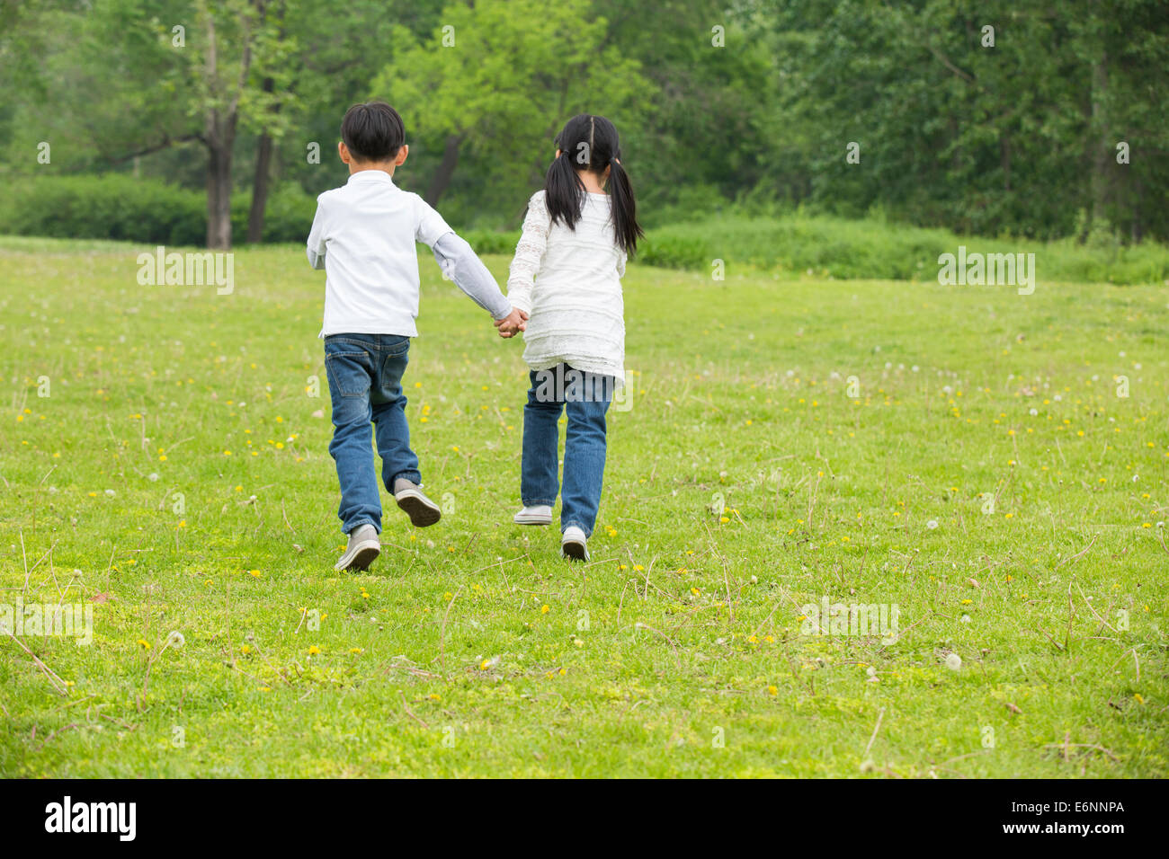 Children holding hands running hi-res stock photography and images - Alamy