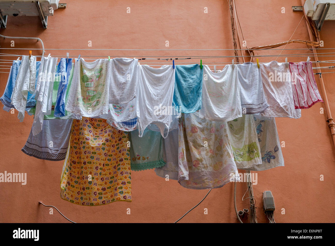 Washing on a washing line with a orange wall as the back ground Stock ...