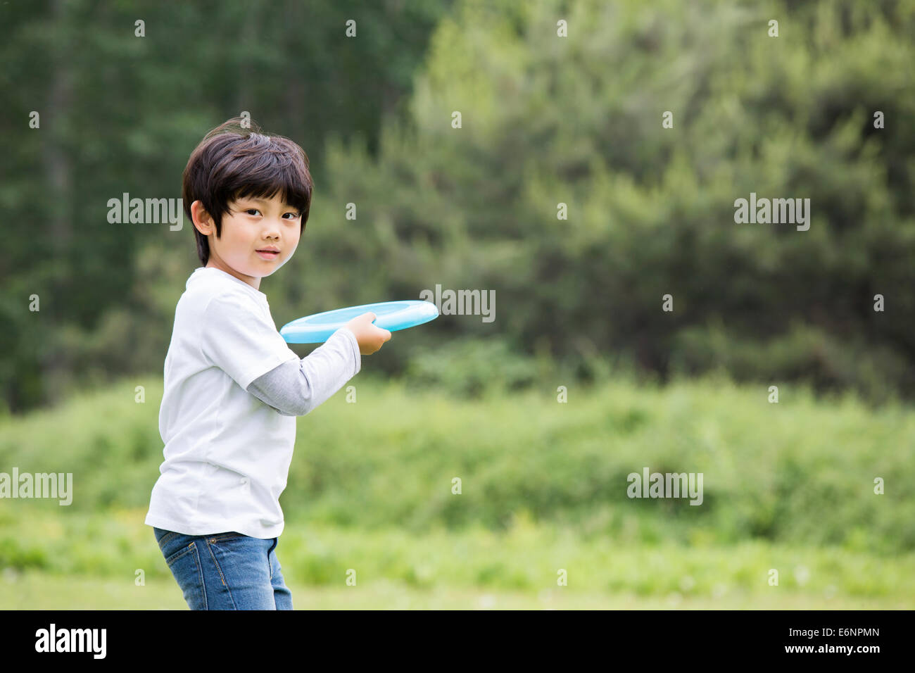 Happy boy playing frisbee Stock Photo - Alamy