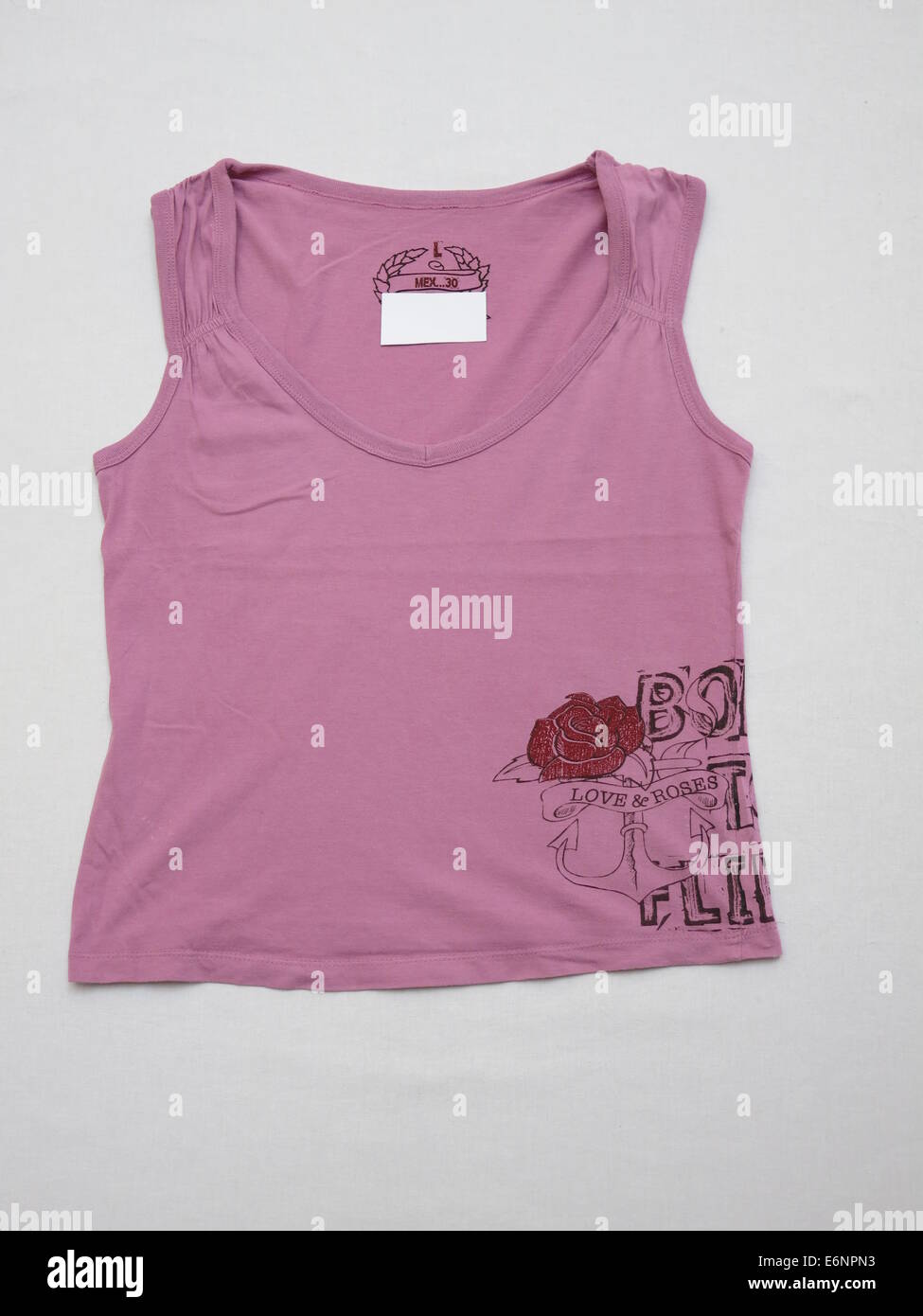 Girl's puce top with a rose print, isolated against white background ...