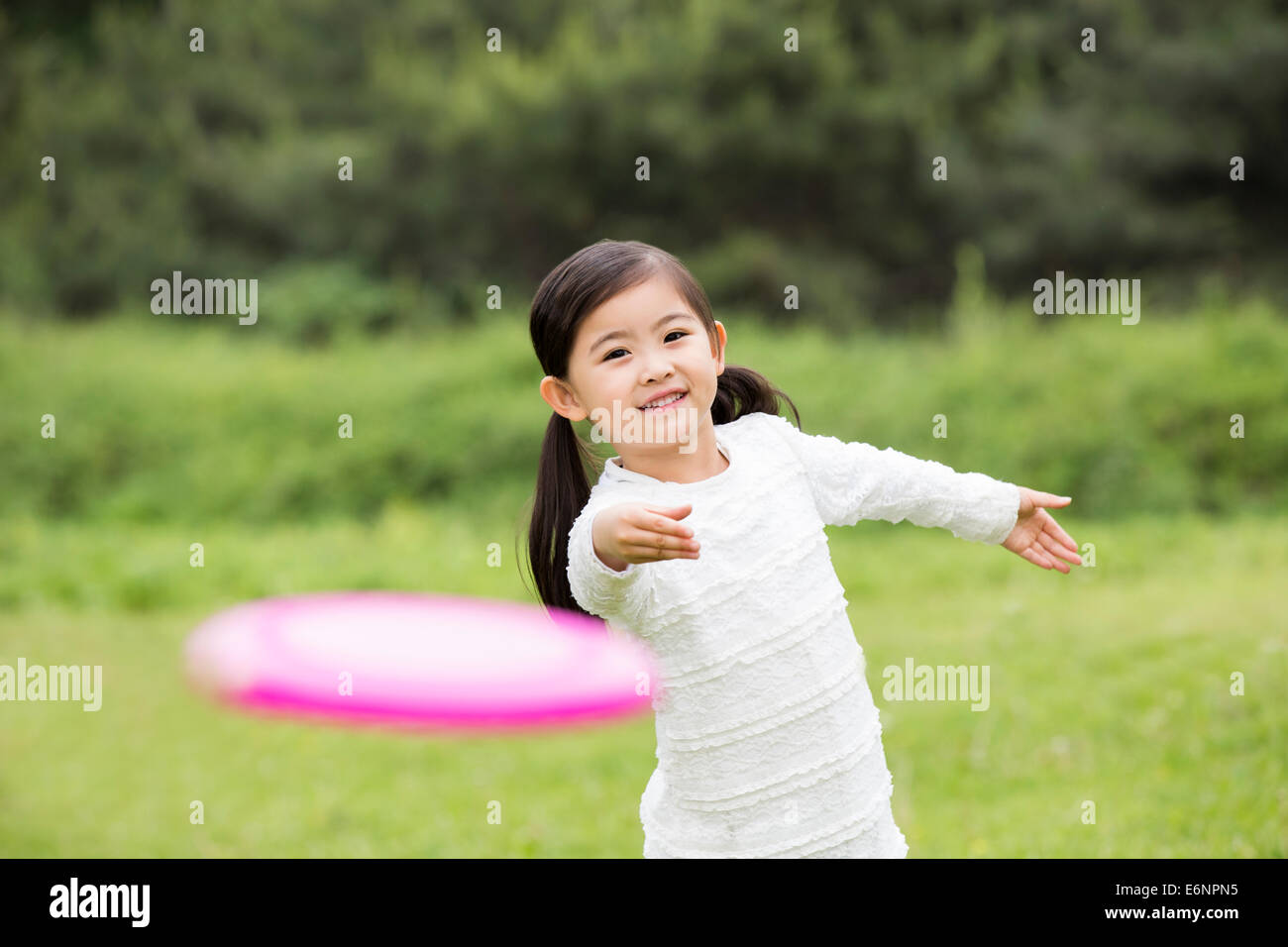 Happy boy playing frisbee Stock Photo - Alamy