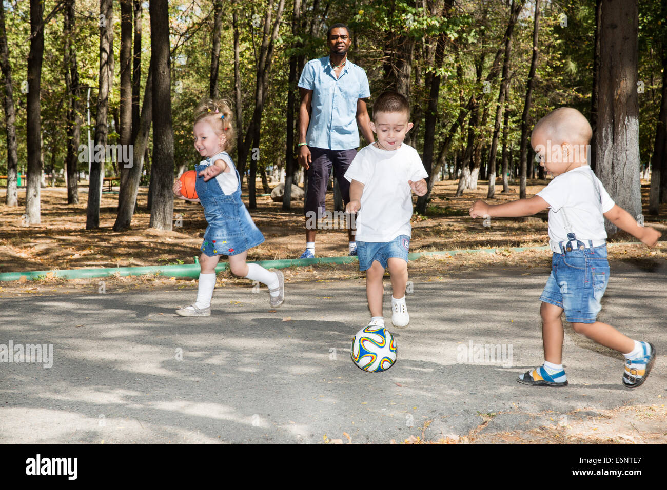 Children playing ball in park hi-res stock photography and images - Alamy