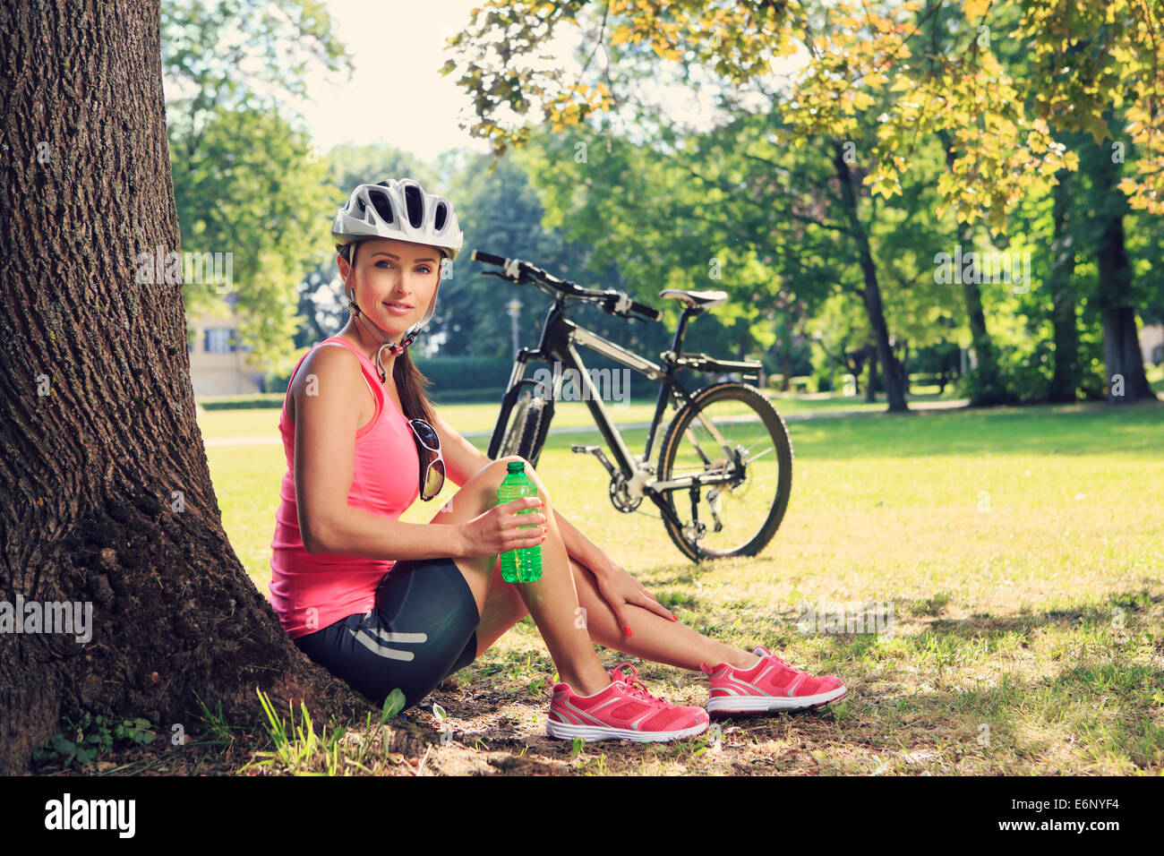 cycling woman taking a break in the park Stock Photo - Alamy