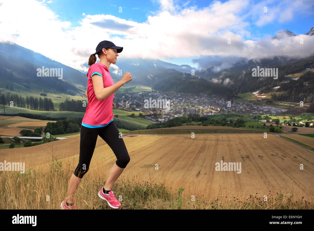 a woman running through the rural landscape Stock Photo - Alamy