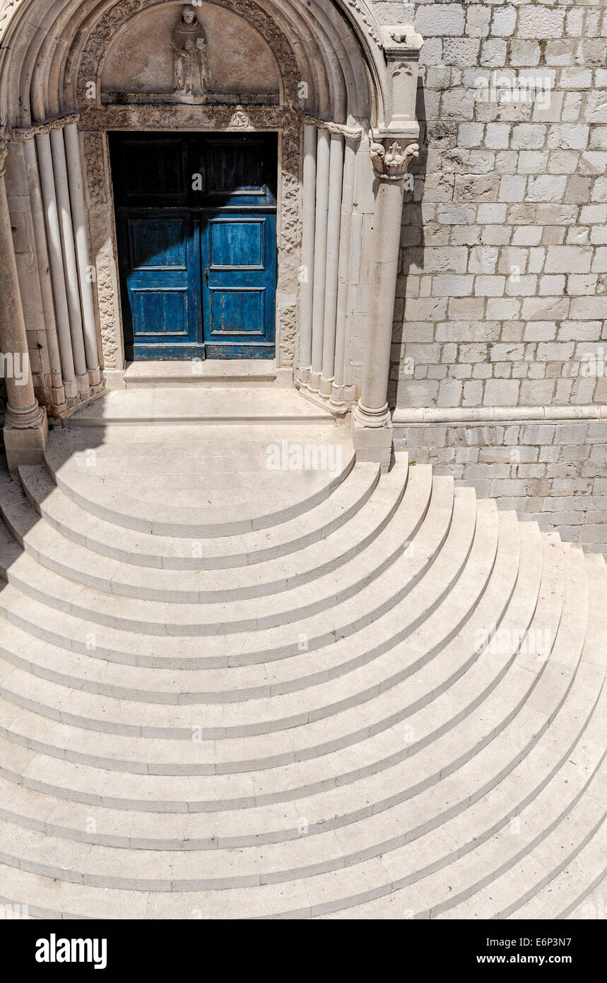 Set of curved stone steps leading to a blue door to a church Stock ...