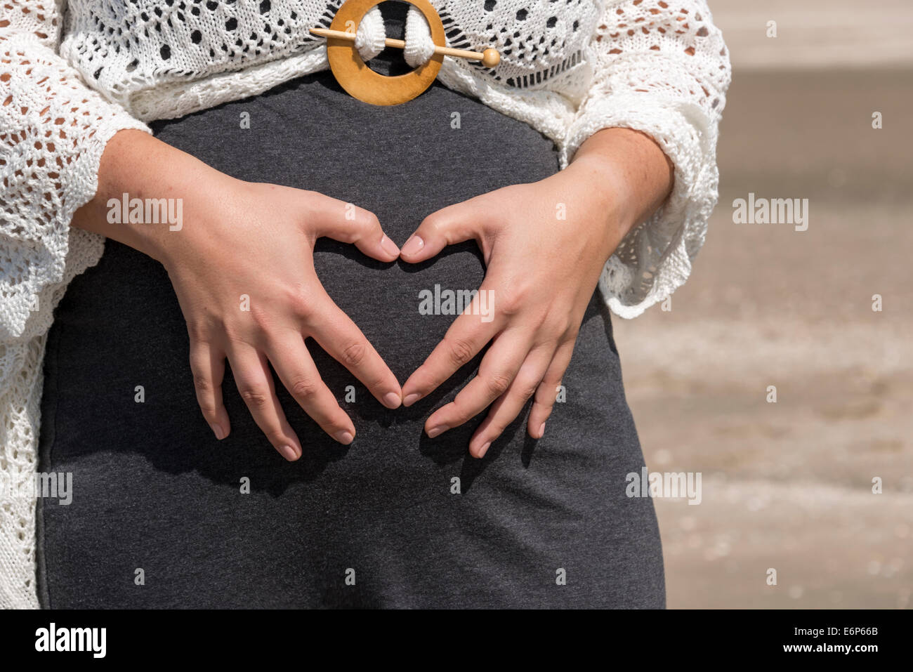 Pregnant belly hands heart hi-res stock photography and images - Alamy
