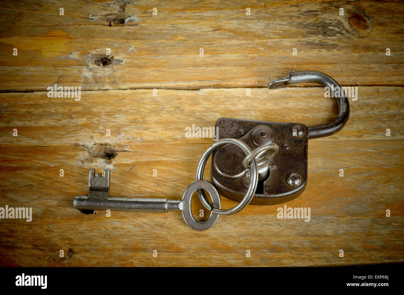 Vintage key inserted in an old padlock Stock Photo - Alamy