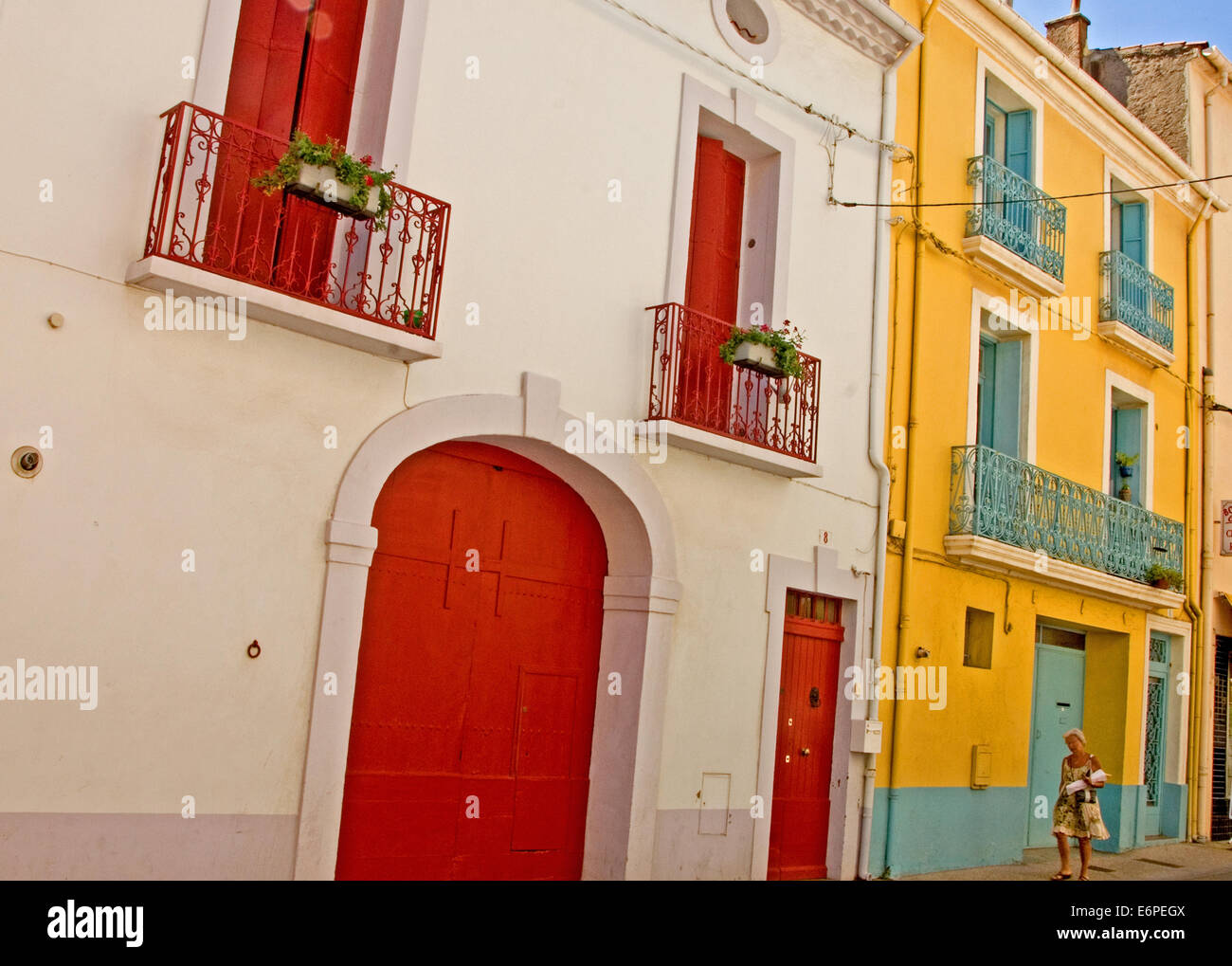 Traditional buildings line a back street in the French town of Meze on ...