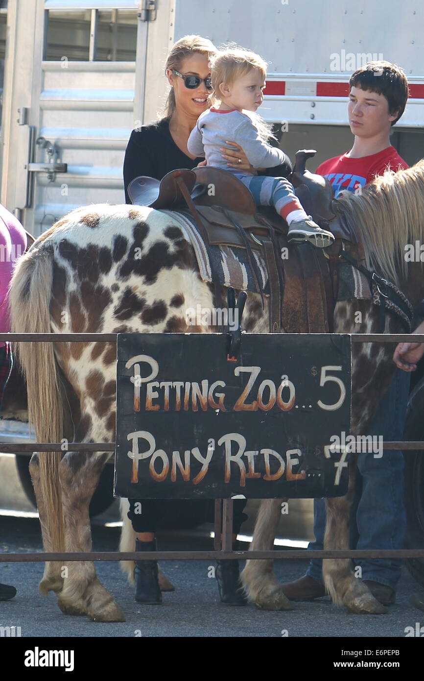 Elizabeth Berkley takes her son, Sky for a pony ride at the farmers ...