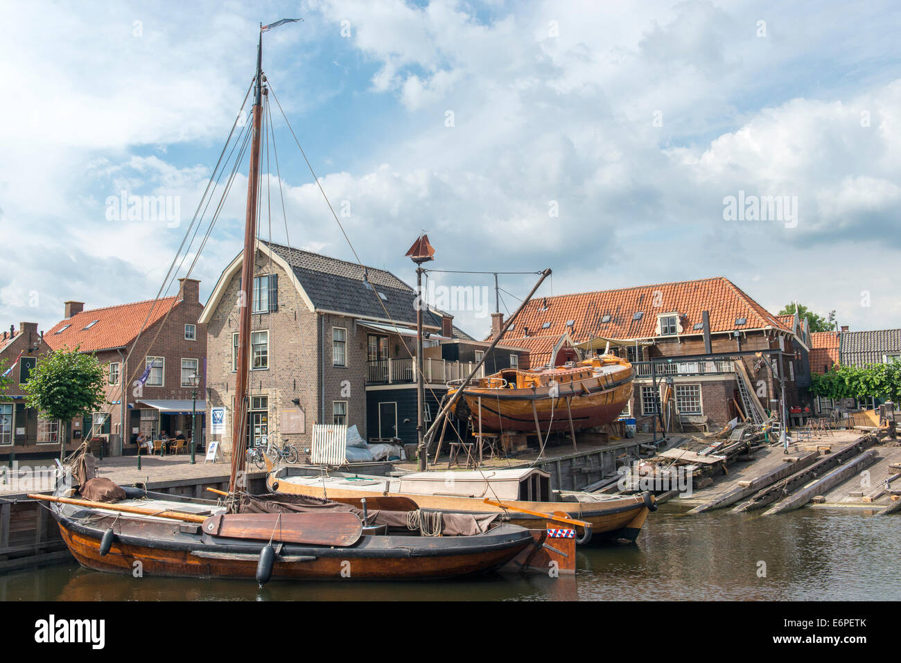 Botters, a type of historical fishing boat, dockyard in the background ...