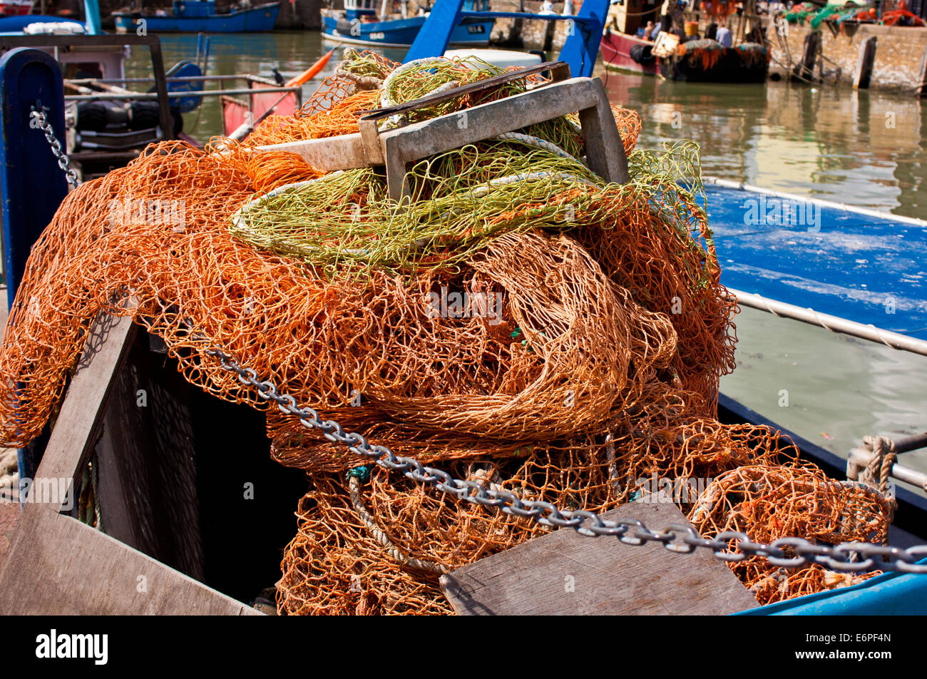A stack of fishing nets on board a boat docked in Whitstable harbour ...