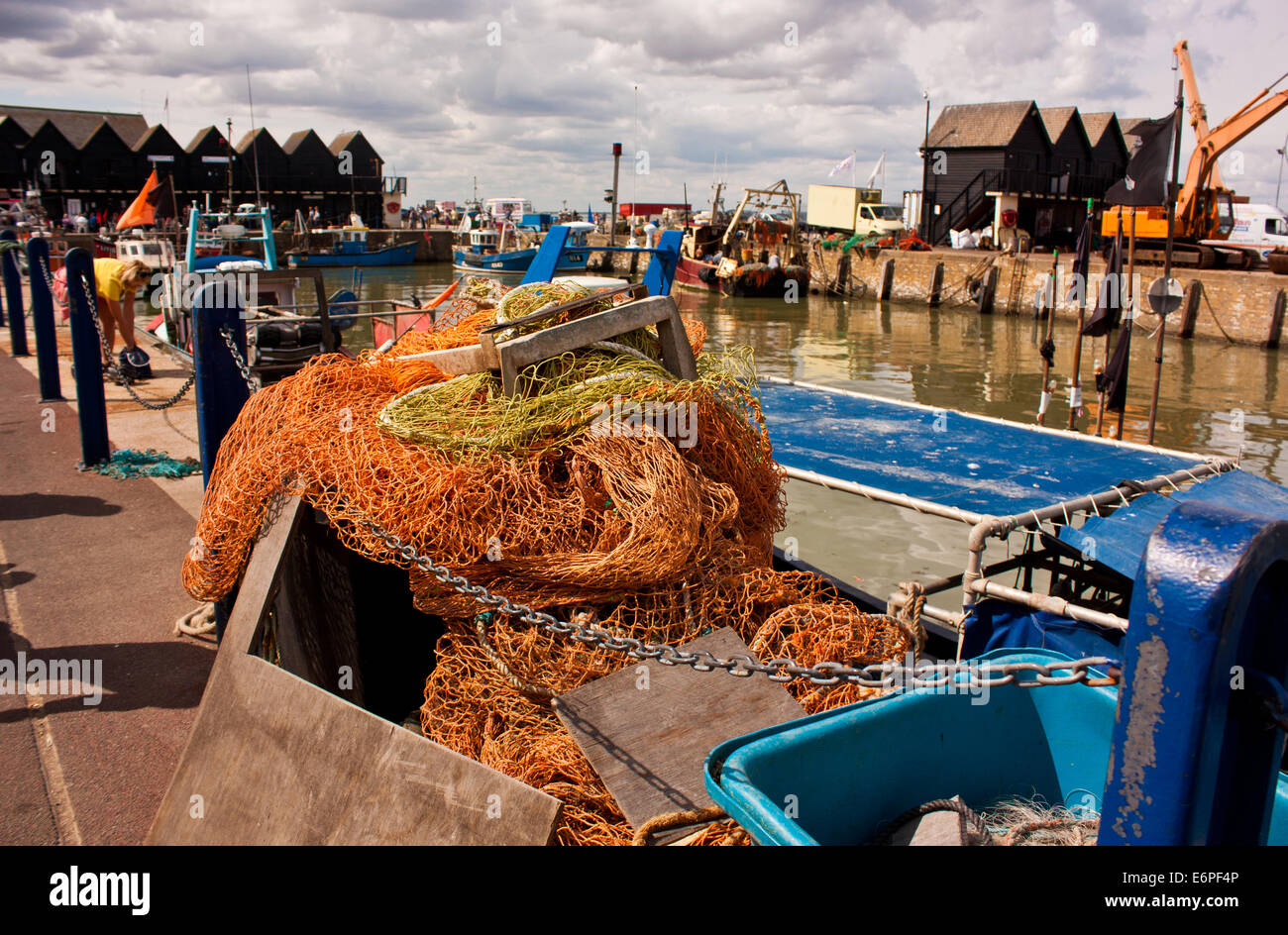 A stack of fishing nets on board a boat docked in Whitstable harbour ...