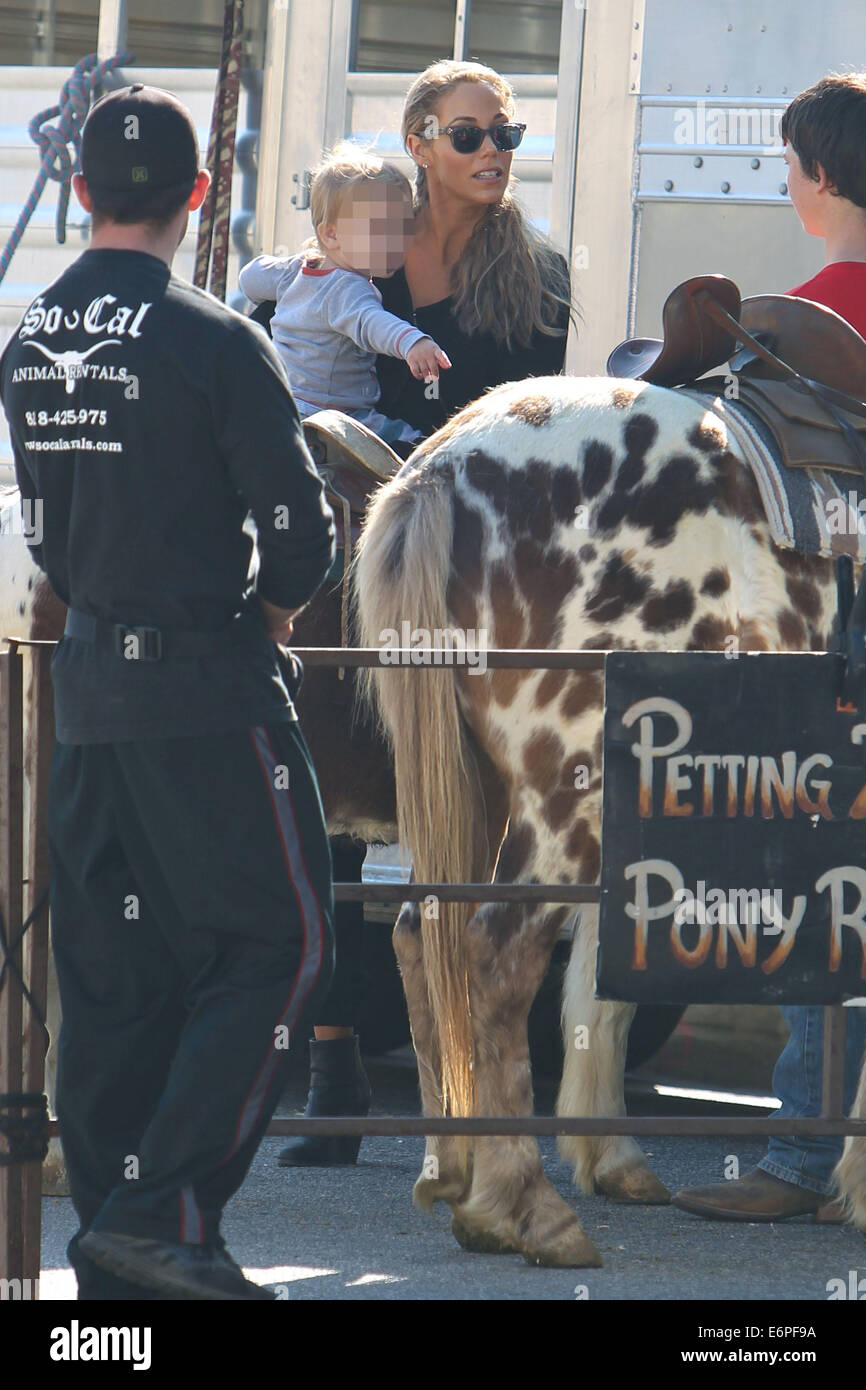 Elizabeth Berkley takes her son, Sky for a pony ride at the farmers ...