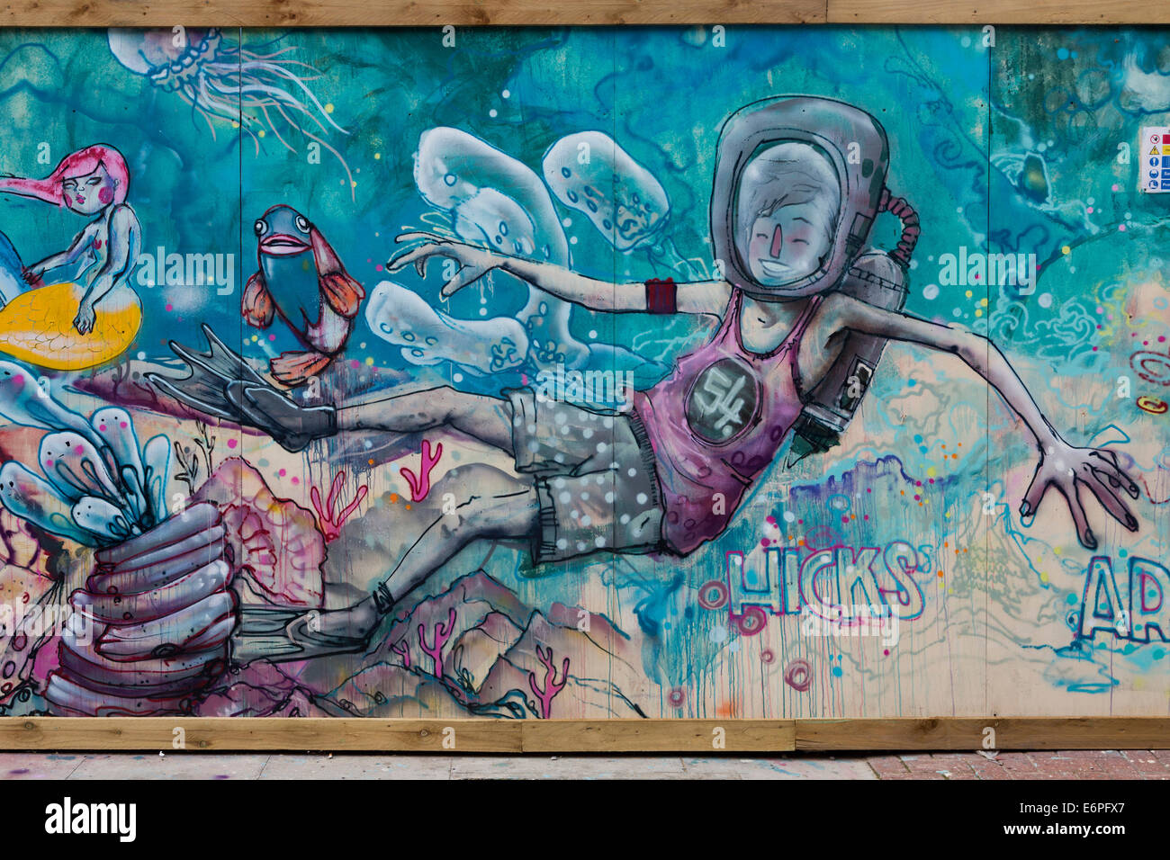 Colourful graffiti of a scuba diver underwater on a façade in the ...