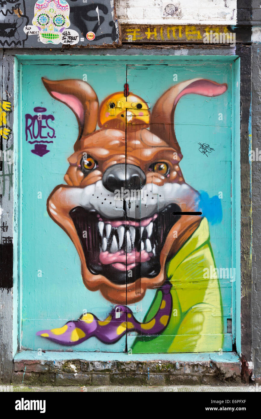 Colourful graffiti of a dog baring its teetch on a façade in the ...