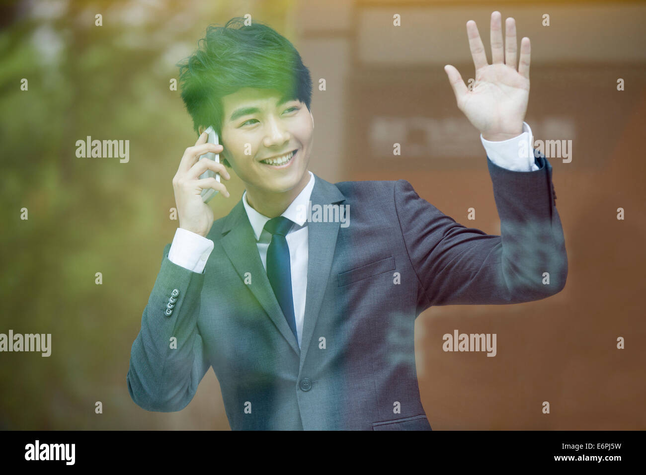 Young businessman greeting someone Stock Photo - Alamy