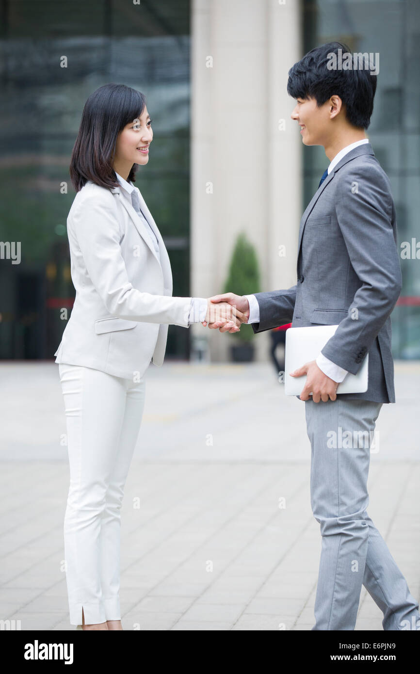 Young business person shaking hands Stock Photo - Alamy