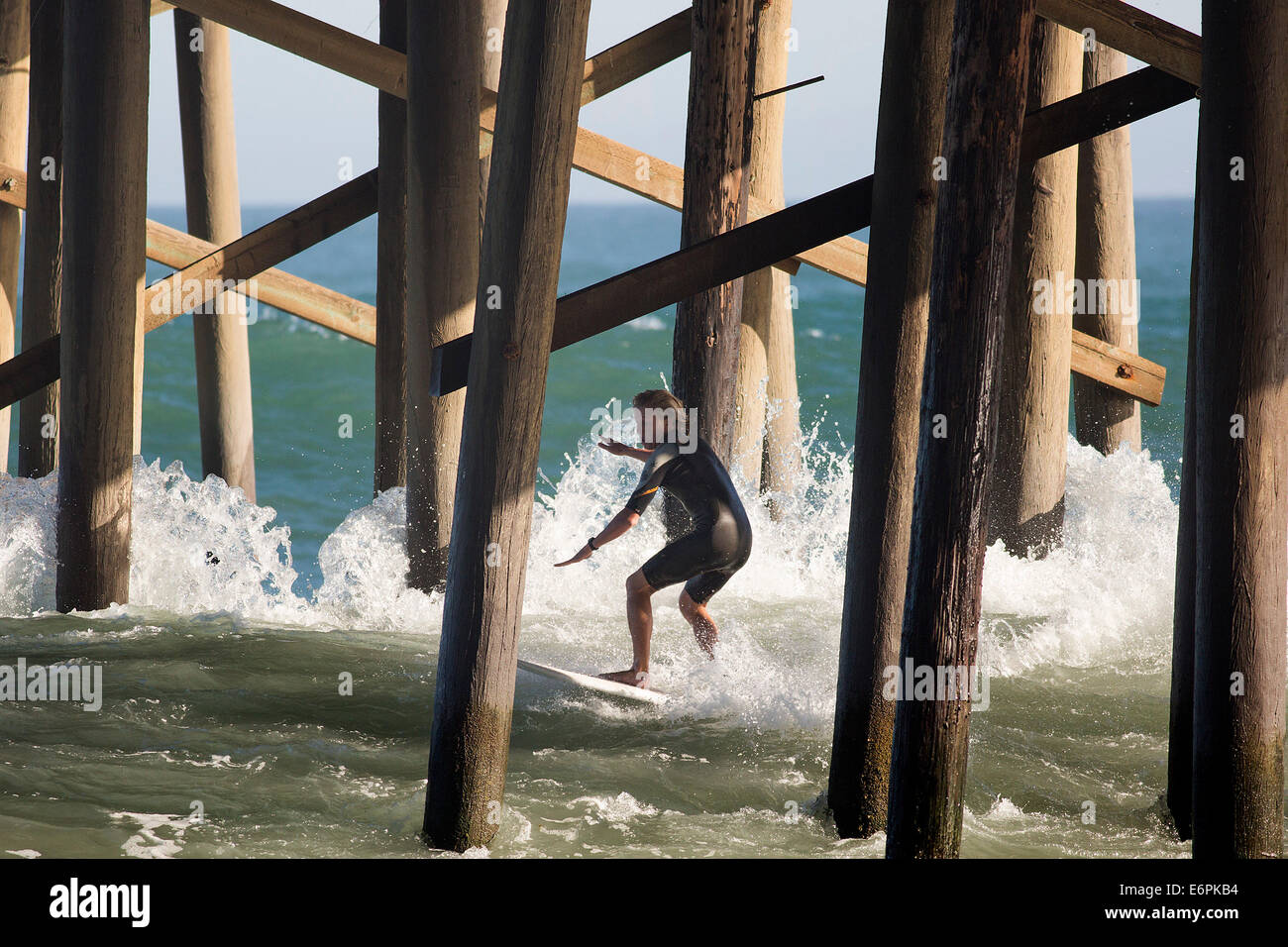 Malibu, California, USA. 27th Aug, 2014. A surfer shoots the pier at ...