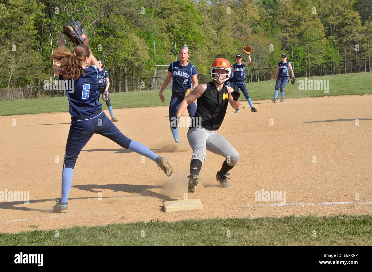 trying to throw the runner out in high school softball Stock Photo - Alamy