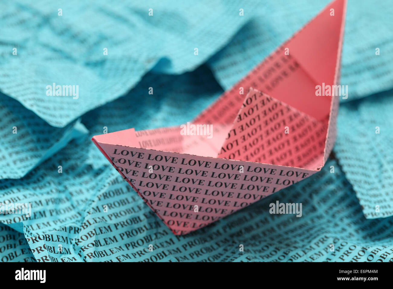 Love boat (paper boat) in the sea of problems Stock Photo - Alamy