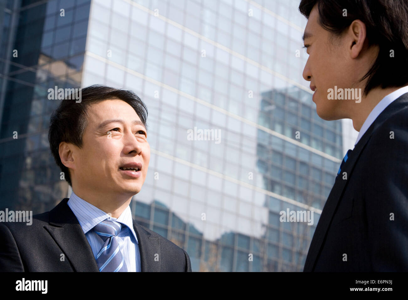 Two businessmen talk business Stock Photo - Alamy