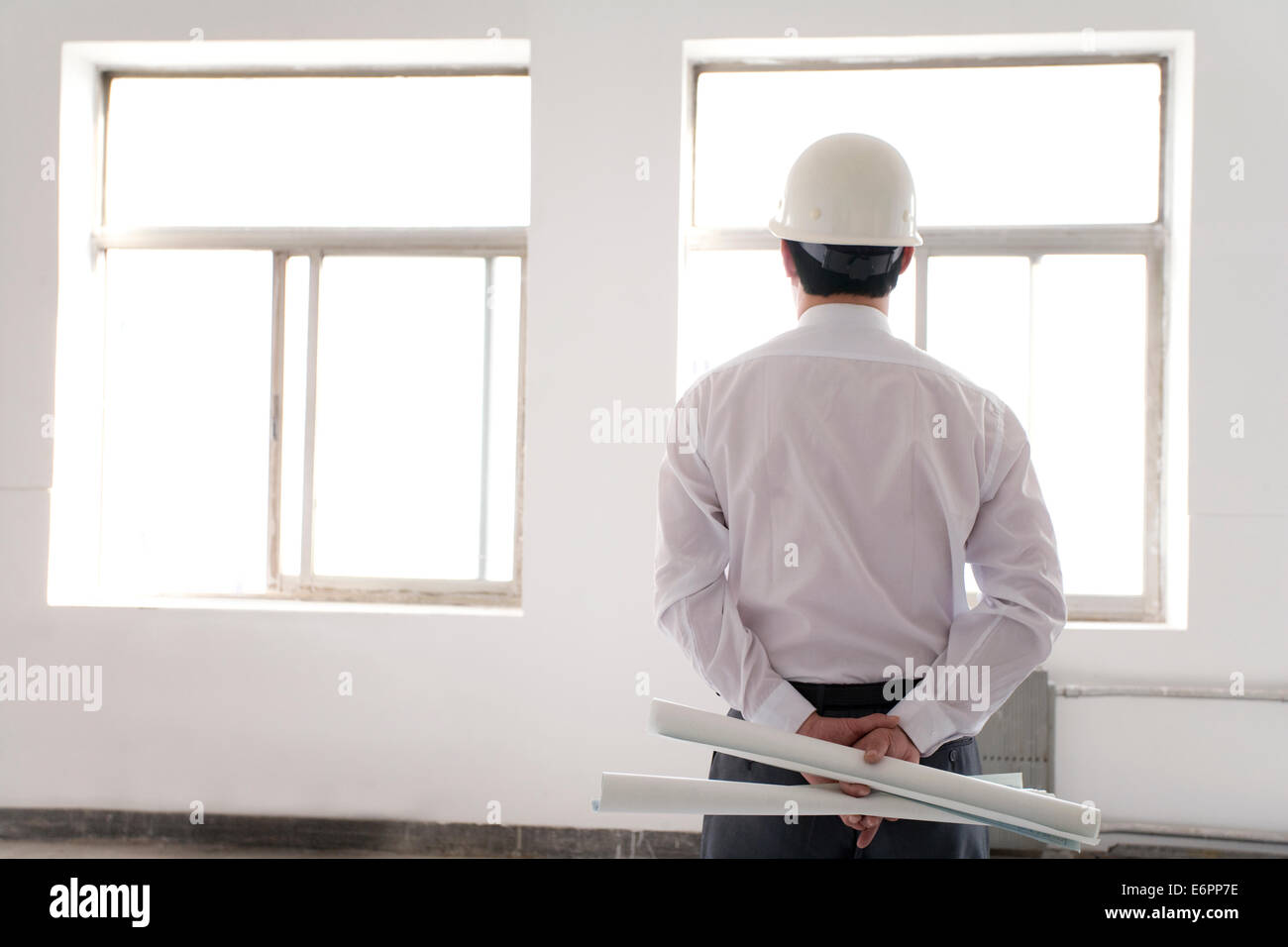 Contractor thinking at construction site Stock Photo - Alamy