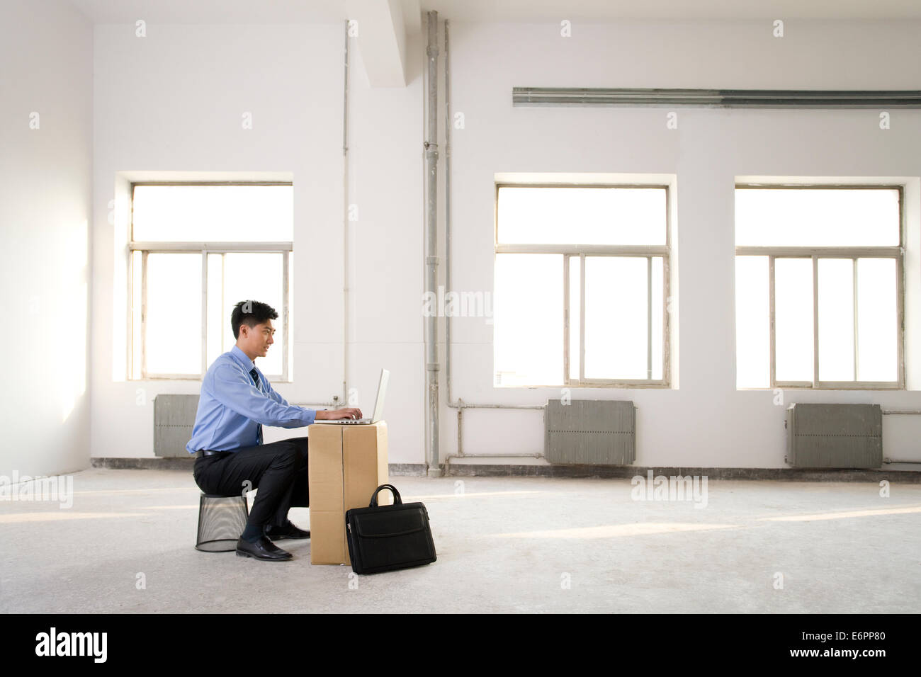 Businessman working in an empty office space Stock Photo - Alamy