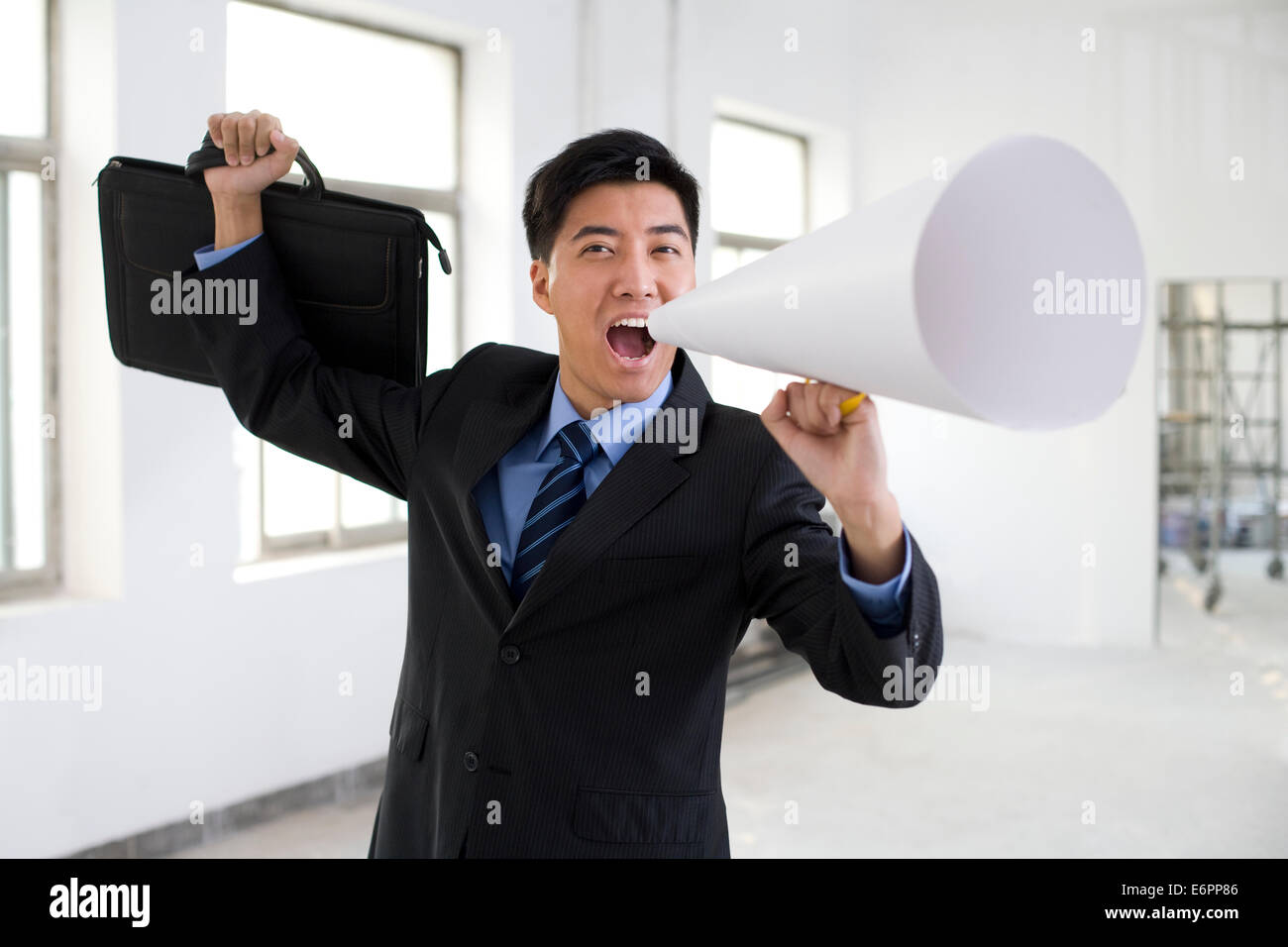 Excited businessman cheering through a megaphone Stock Photo - Alamy